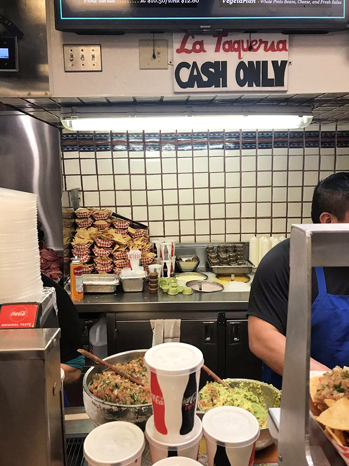 Behind the counter, where magic happens daily. Fresh ingredients stand ready to be transformed into legendary meals by skilled hands.