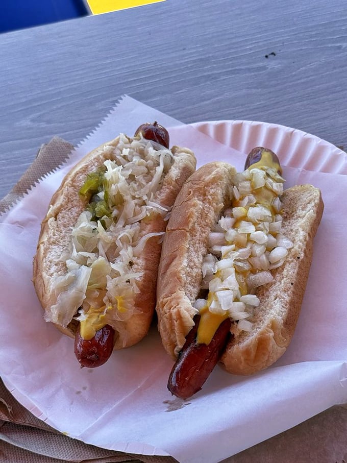Two hot dogs dressed to impress with the classic trio of kraut, mustard, and relish&mdash;proof that sometimes tradition knows best.
