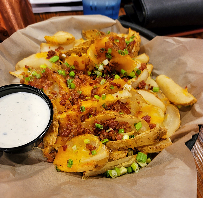 Loaded fries that make you question why you've wasted time on plain ones all these years. That dipping sauce deserves its own fan club.