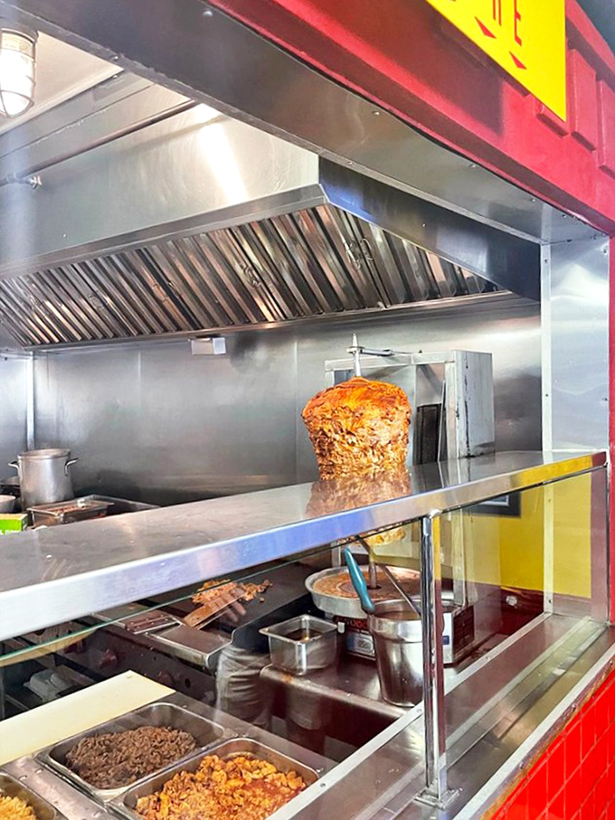 Meat poetry in motion. That vertical spit of marinated pork is slowly caramelizing to perfection, promising flavor that chain restaurants can only dream about.