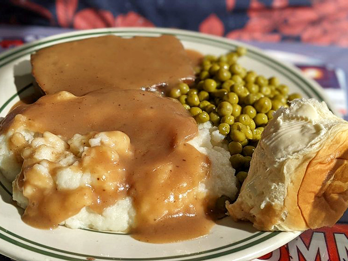 Meatloaf that would make your grandmother simultaneously proud and jealous, swimming in gravy that deserves its own national holiday.