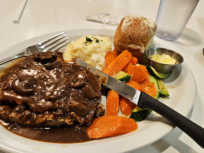 Meatloaf swimming in rich gravy alongside cloud-like mashed potatoes &ndash; comfort food that whispers "everything's going to be okay" with every bite.