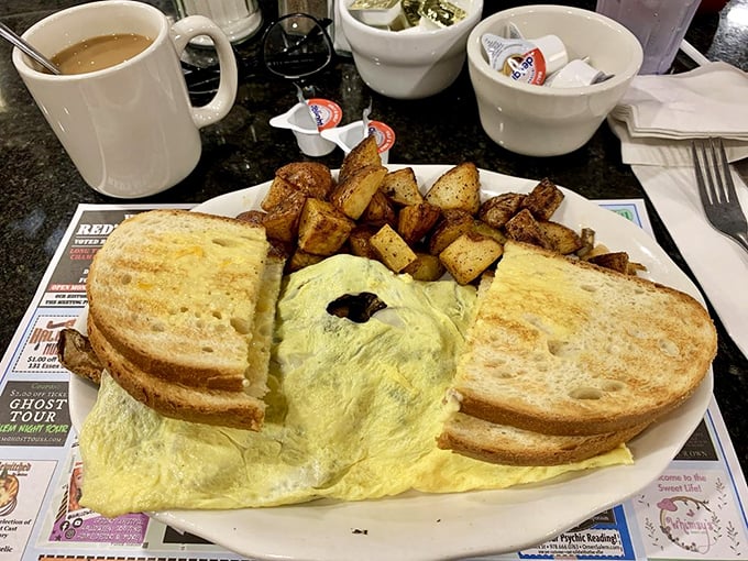 An omelet so fluffy it could float away if not anchored by perfectly crisp toast and seasoned home fries.