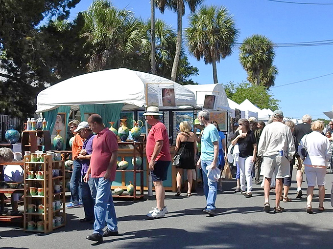 Artists and admirers mingle under white tents during Cedar Key's art festivals, where finding your next wall treasure comes with Gulf breezes and no admission fee.