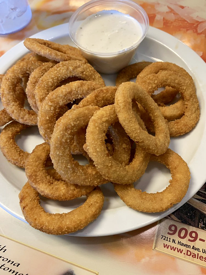 Onion rings that don't hide behind pretentious beer batters &ndash; just honest-to-goodness golden circles of joy with ranch dipping sauce.