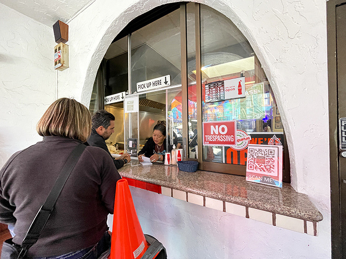 The ordering window: where dreams and hunger meet. Keep your order clear and your cash ready&mdash;efficiency is part of the experience.