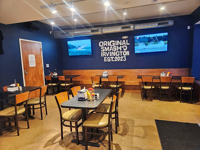 Blue walls, exposed ductwork, and that glowing Smash'd logo create the perfect backdrop for burger epiphanies. Edison would approve of both the lighting and the inventiveness.