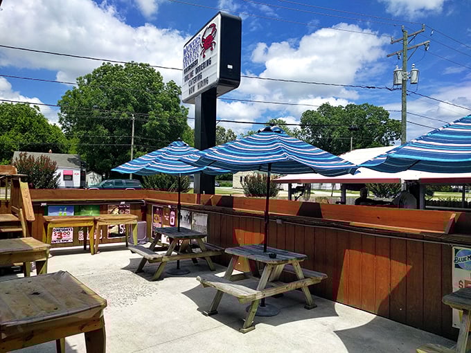 Blue umbrellas create islands of shade on the casual patio. The perfect spot for cracking crabs while catching summer breezes.