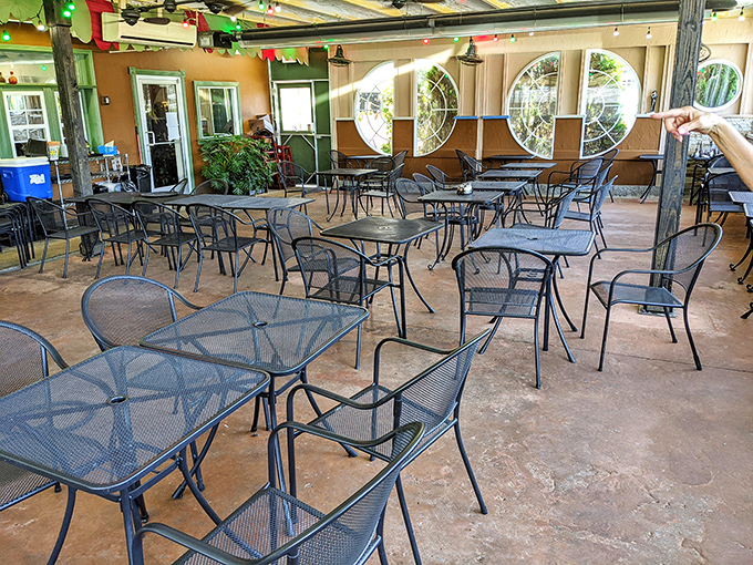 The outdoor seating area waits patiently for the dinner rush, like an empty stage before the nightly performance of "Italians Feeding Americans" begins.