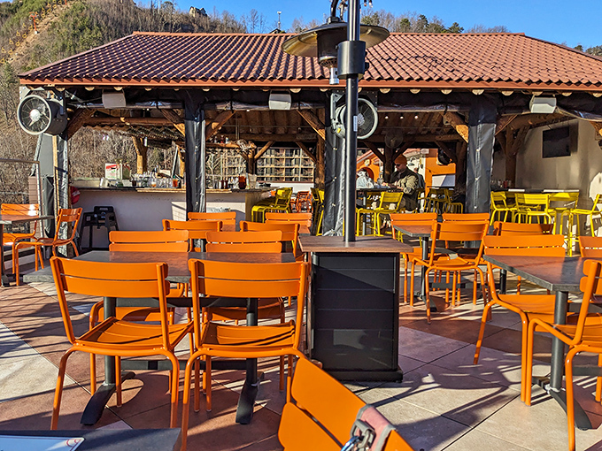 Vibrant orange chairs under the Tennessee sun create the perfect stage for afternoon margaritas and mountain views at Loco Burro's outdoor seating area.
