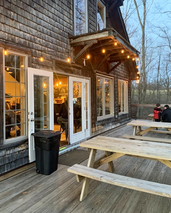 As evening approaches, string lights twinkle above the outdoor seating area, transforming an ordinary deck into a magical wine garden.