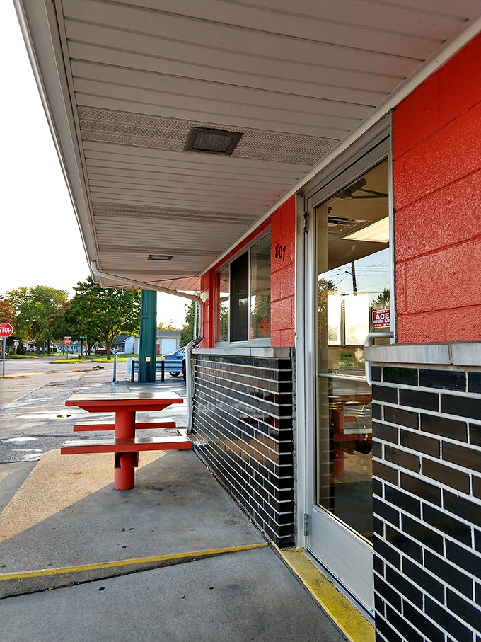 Al fresco dining, drive-in style. This red picnic table has hosted more genuine food moments than any white-tablecloth restaurant could ever claim.