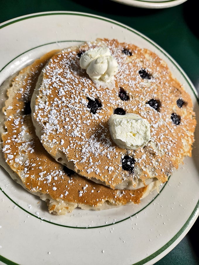 Blueberry pancakes with butter islands slowly melting into sweet oblivion. The powdered sugar is just showing off at this point.
