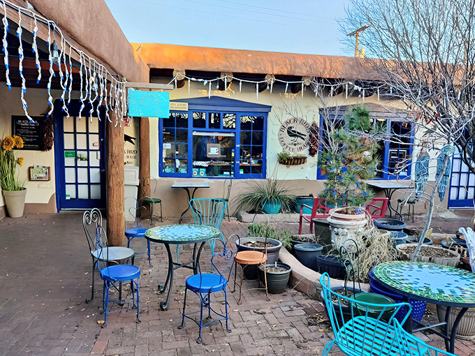 Desert-chic outdoor seating. Turquoise tables pop against adobe walls, creating the perfect spot to sip your latte while soaking in Albuquerque's famous blue skies.