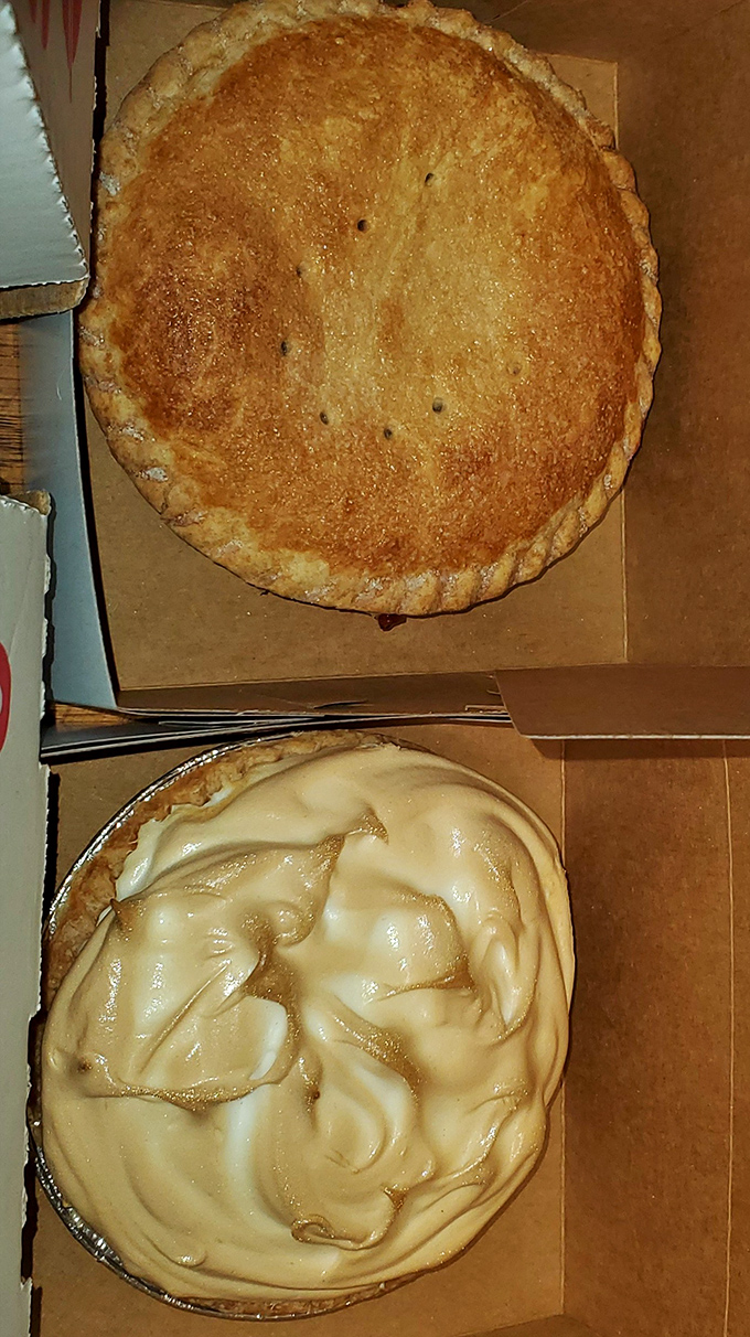 The yin and yang of pie perfection: golden-crusted fruit pie alongside a cloud-like meringue creation that defies gravity.