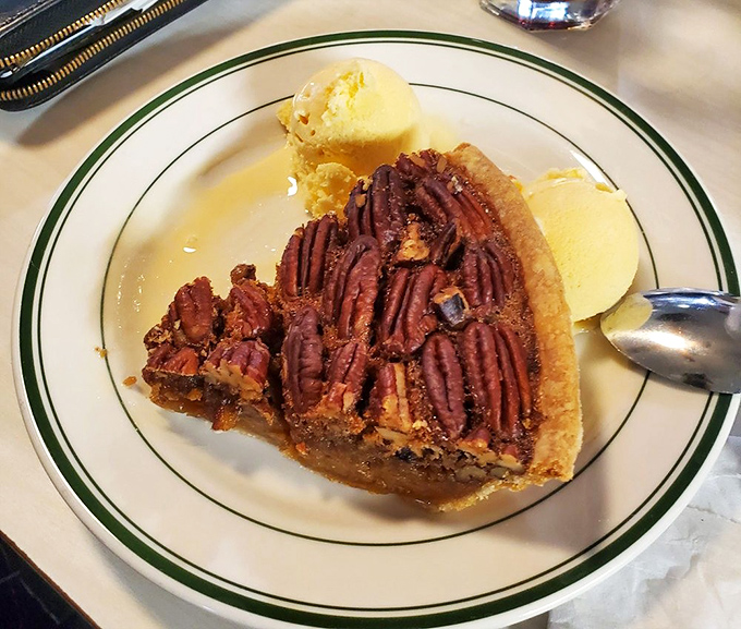 This pecan pie with a scoop of vanilla ice cream creates the kind of sweet-and-nutty harmony that makes you temporarily forget about your diet, your worries, and possibly your name.