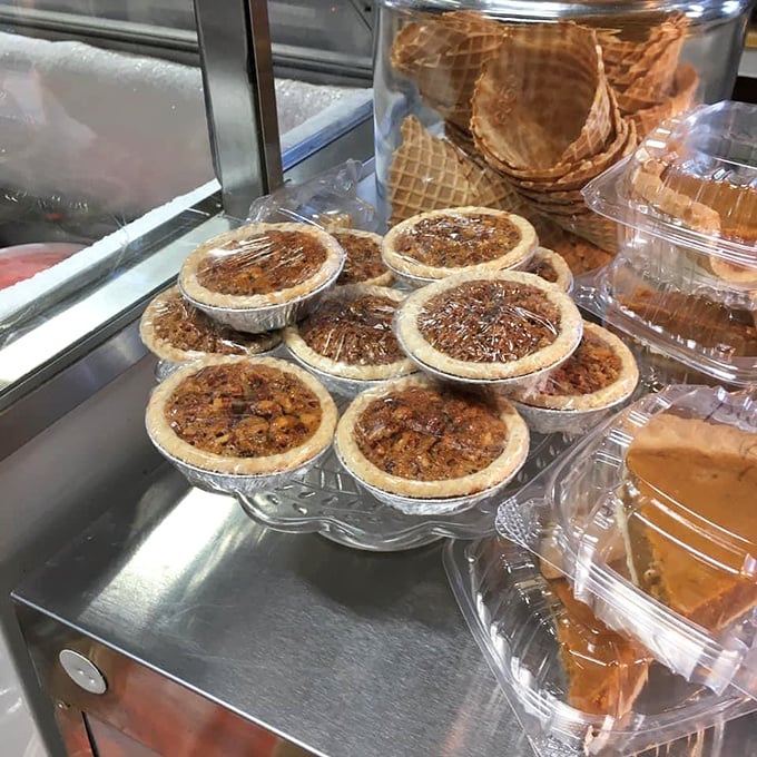 Pecan pies lined up like soldiers ready for dessert duty, their glossy tops promising the perfect balance of sweet filling and buttery crust.