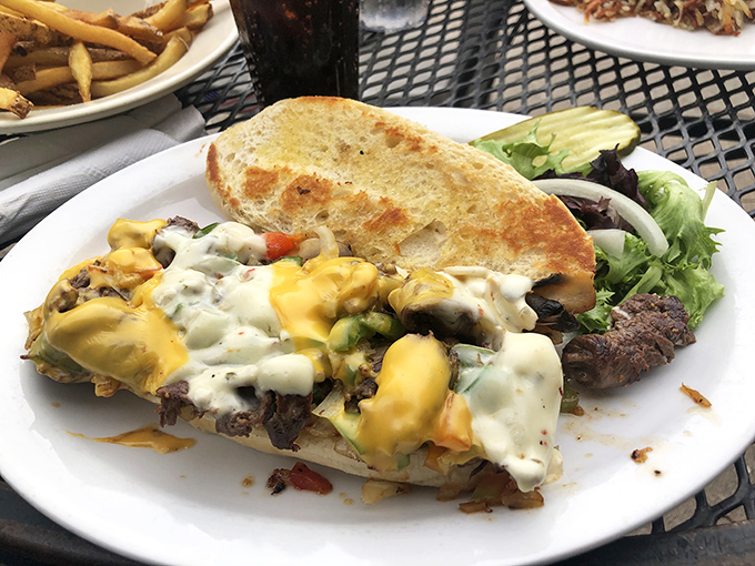 This isn't just a sandwich&mdash;it's a cheese-draped monument to hunger with mushrooms and peppers playing supporting roles.