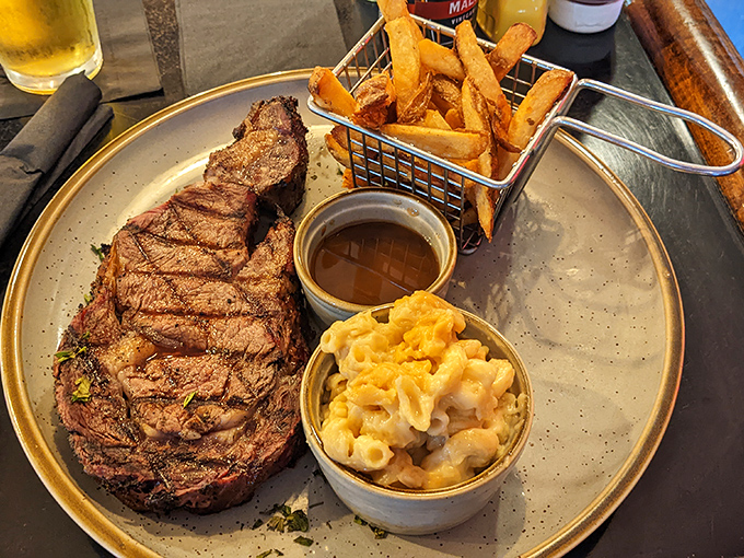 This isn't just a steak; it's a commitment. Perfectly grilled beef with sides of mac and cheese and fries for the ultimate comfort trifecta.