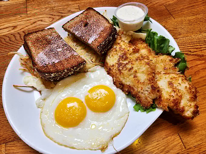 Perfectly fried eggs alongside golden toast and what appears to be a crispy fish fillet &ndash; the breakfast of coastal champions.