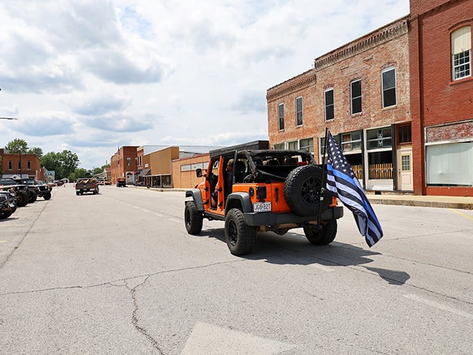 A Jeep proudly flying the thin blue line flag cruises down Main Street, part of the parade of everyday life in a town where patriotism isn't just for holidays.