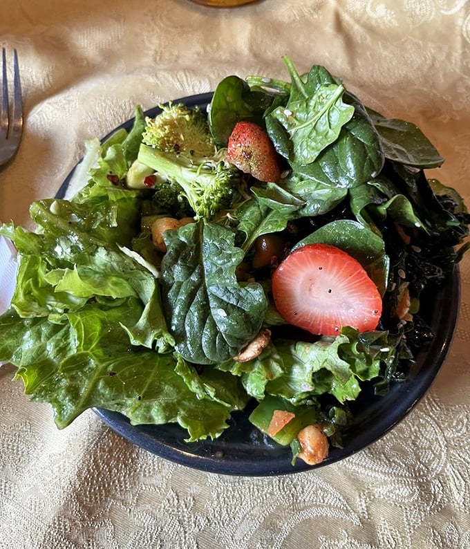 Fresh greens and strawberries dance together on the plate, making you wonder why salads elsewhere seem so uninspired by comparison.