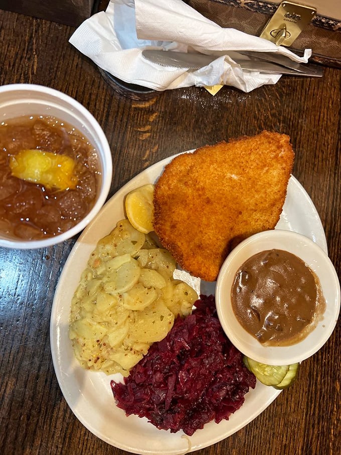 This schnitzel plate is a geography lesson on a dish &ndash; golden breaded cutlet bordering vibrant red cabbage and creamy potato salad.