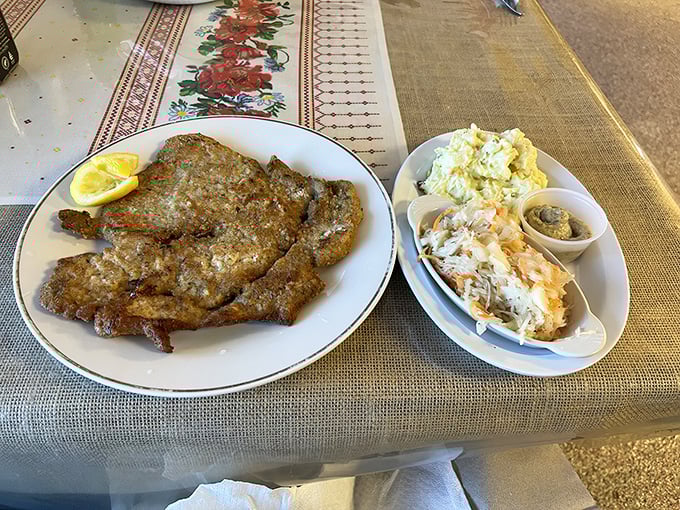 Schnitzel so perfectly golden it deserves its own medal, accompanied by sides that refuse to be overshadowed despite the competition.