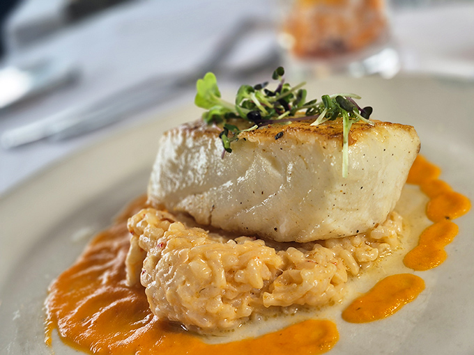 This sea bass doesn't just sit on risotto&mdash;it reigns over it, with those orange sauce accents adding both color and a flavor exclamation point. 