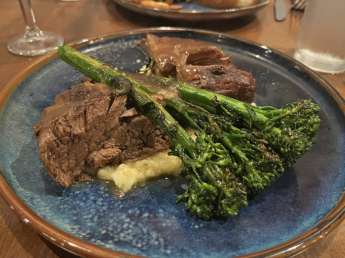 Beef short rib so tender it surrenders to your fork without a fight, keeping company with broccolini that's anything but an afterthought.