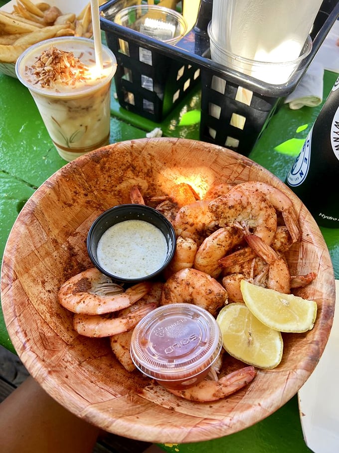 Peel-and-eat shrimp served in a wooden bowl with two dipping sauces and fresh lemon&mdash;seafood simplicity that makes you wonder why anyone complicates things.