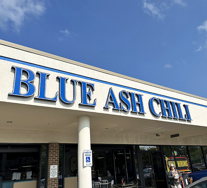 The bold blue lettering against white isn't just signage&mdash;it's a beacon for those seeking Cincinnati's iconic chili experience without pretense or fuss.