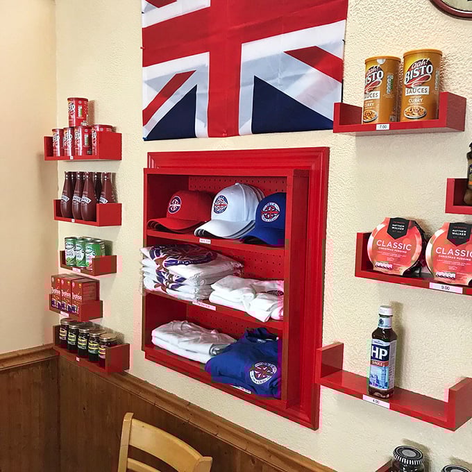 The souvenir wall offers a taste of Britain to take home. HP Sauce, British flags, and branded merchandise let you extend the experience beyond your meal.