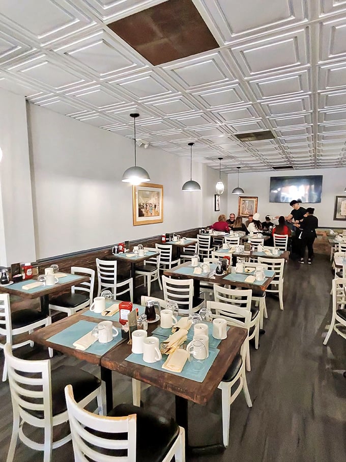 Lush greenery frames the window seats where regulars linger over second cups of coffee, reluctant to return to the real world.