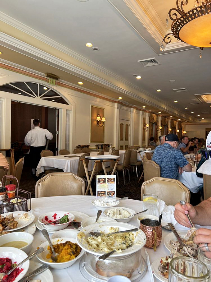 A dining room where white tablecloths meet family-style service, proving that comfort food can still feel like a special occasion.