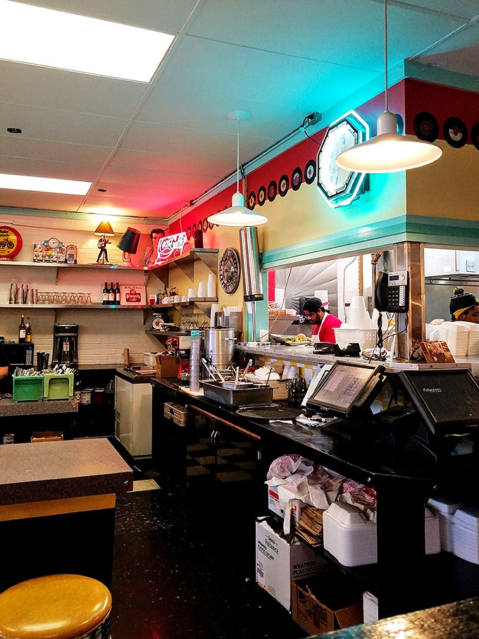 Behind the counter, culinary magic happens under the glow of neon and nostalgia, where short-order cooking becomes performance art.