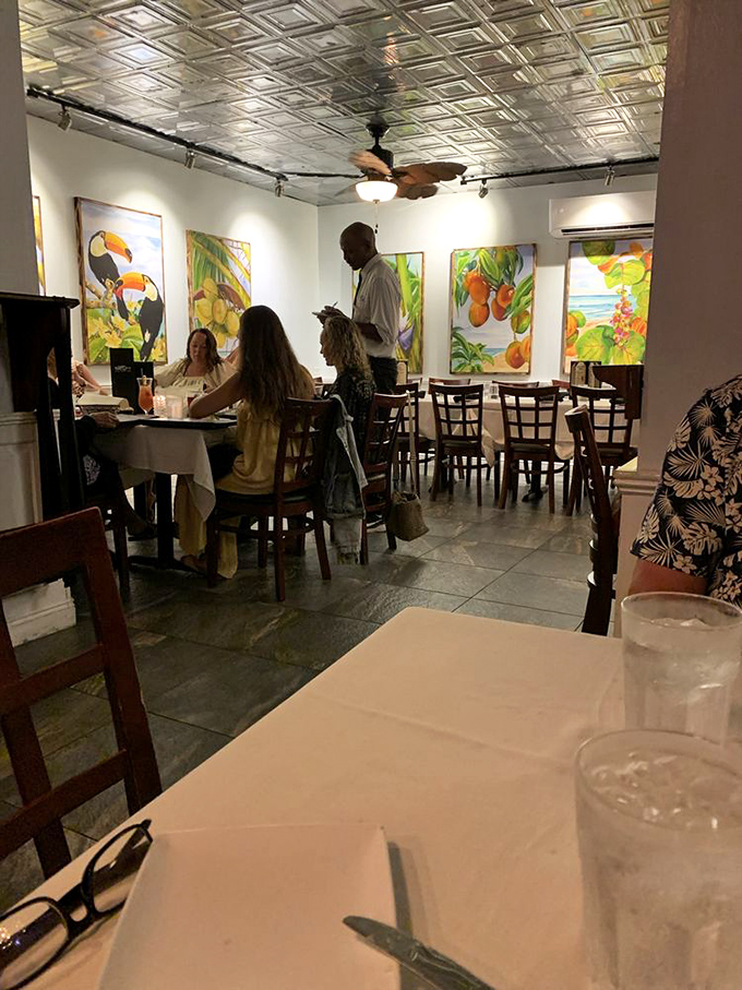 Tropical-themed artwork brightens the dining room while attentive staff ensures your glass never reaches the dreaded empty state.