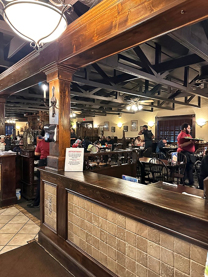 The dining room buzzes with the beautiful chaos of a successful restaurant. That wooden beam structure overhead feels like dining in a rustic Italian villa.