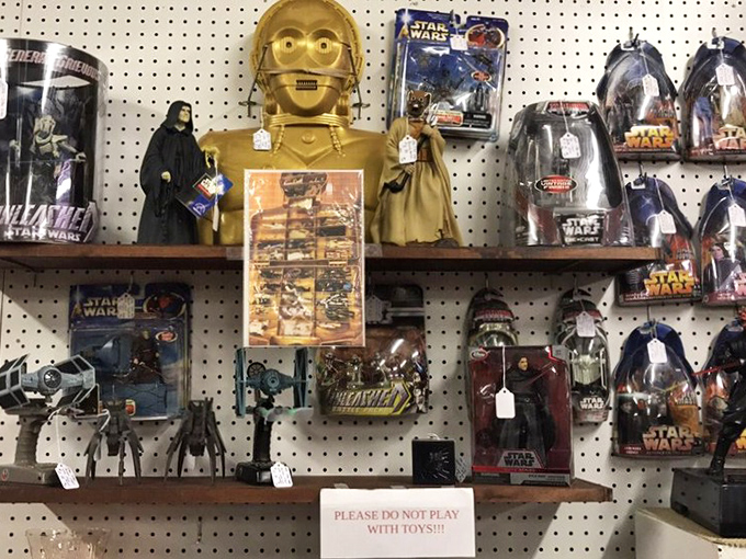 C-3PO stands guard over a galactic collection of Star Wars memorabilia. The Force is strong with this vendor's pricing strategy.