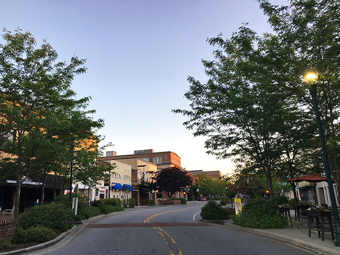 Sunset casts a golden glow on Hendersonville's tree-lined streets, where the evening pace slows to match the lengthening shadows.