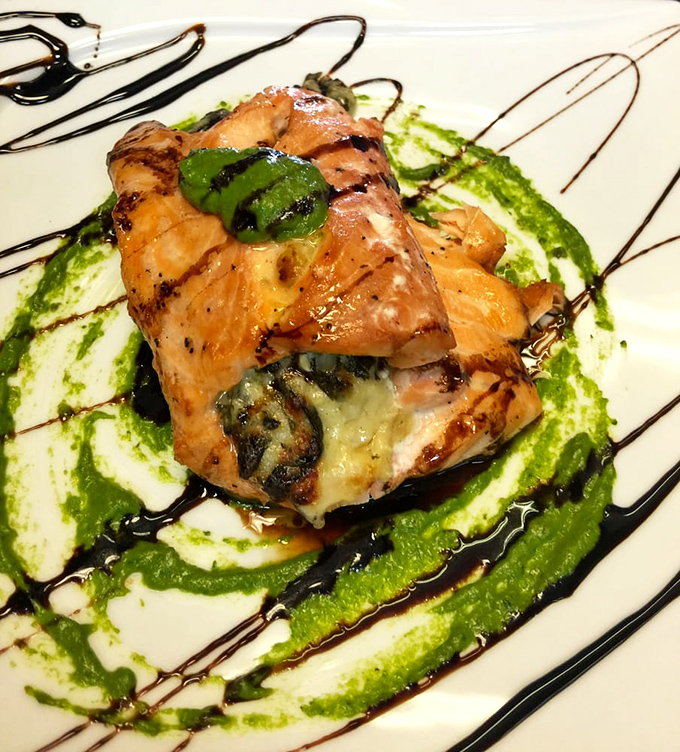 Salmon transformed into a canvas for culinary artistry, with verdant sauce creating a Jackson Pollock-worthy plate that tastes even better than it looks.