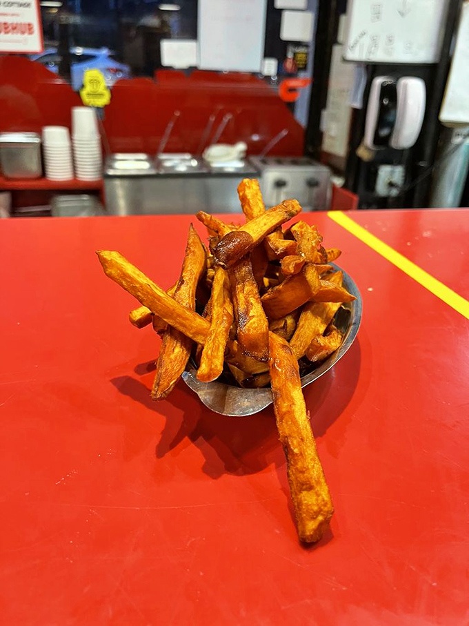 Sweet potato fries stacked like golden Lincoln Logs. These crispy, caramelized beauties might just upstage the burger they're meant to accompany.