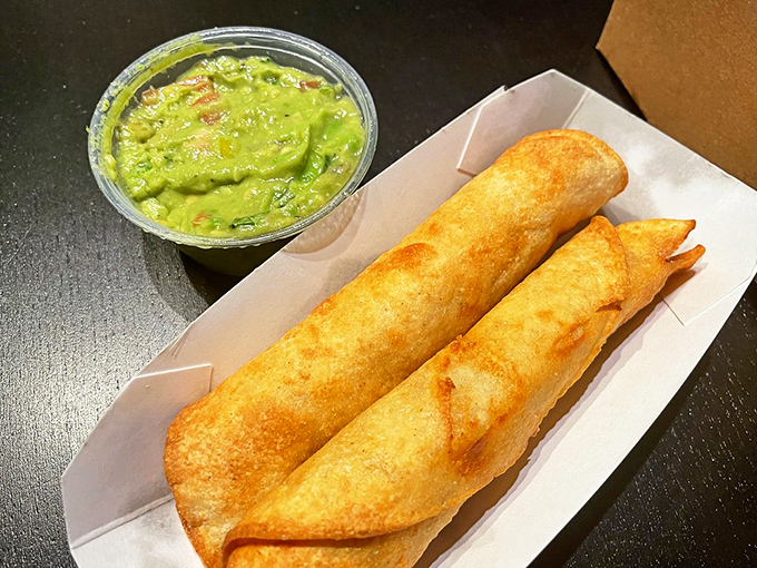 Crispy taquitos with a side of vibrant guacamole. These golden tubes of joy prove Tops' menu extends beyond traditional diner fare into SoCal favorites.