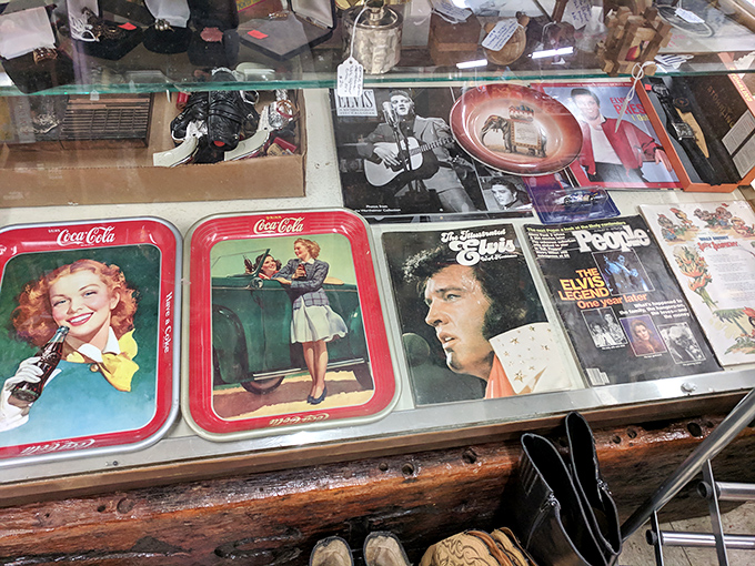 Elvis hasn't left the building&mdash;he's just moved to this display case. Vintage Coca-Cola trays share space with the King's memorabilia.