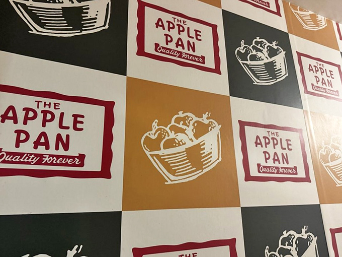 The checkerboard wall of Apple Pan logos serves as a reminder that some branding doesn't need to change when it was perfect from day one.