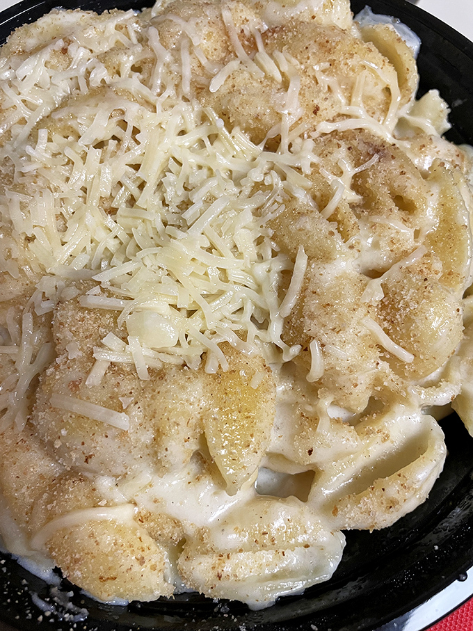 Delicate shreds of cheese crown this creamy masterpiece, proving that sometimes more cheese is the only reasonable answer.