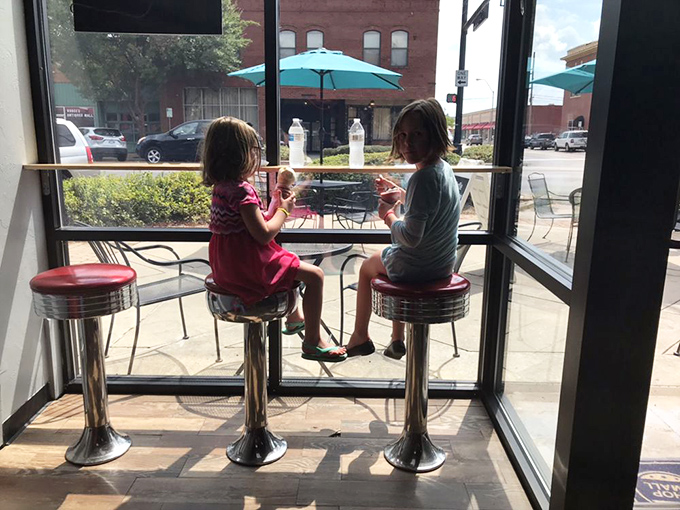 Window seats and classic diner stools&mdash;where custard memories are made. These young connoisseurs understand that serious dessert requires proper seating arrangements.