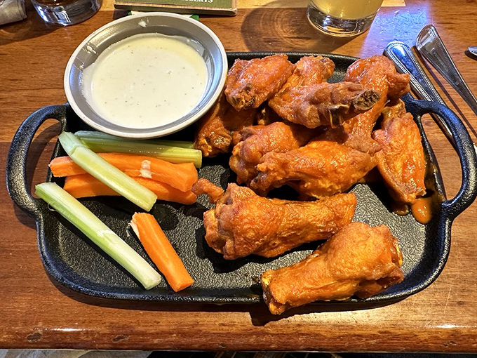 Wings that demand to be noticed. Vibrant orange sauce clings to each piece, promising a flavor explosion that requires extra napkins.