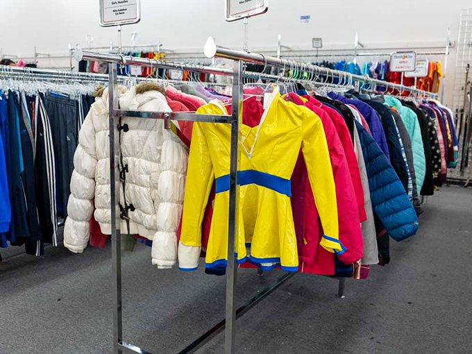 Winter coats and vibrant jackets stand at attention, including what appears to be a cheerleading uniform waiting for its next "Go team!"