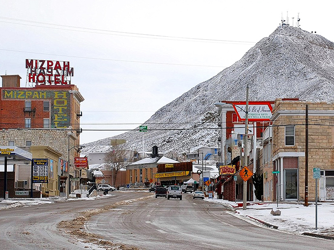 Winter transforms Tonopah's historic Main Street into a postcard-perfect scene where the Mizpah Hotel's vintage sign stands out against the snow-dusted mountain backdrop.